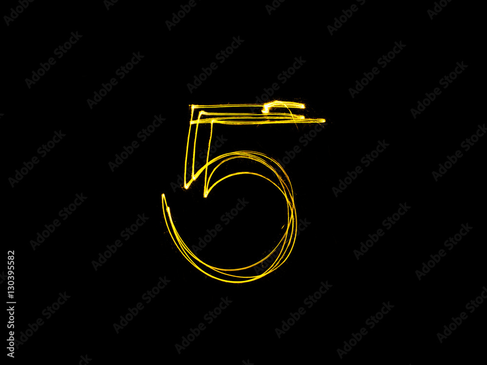 burning sparkler stick and writing sparkling text . number five foto de ...