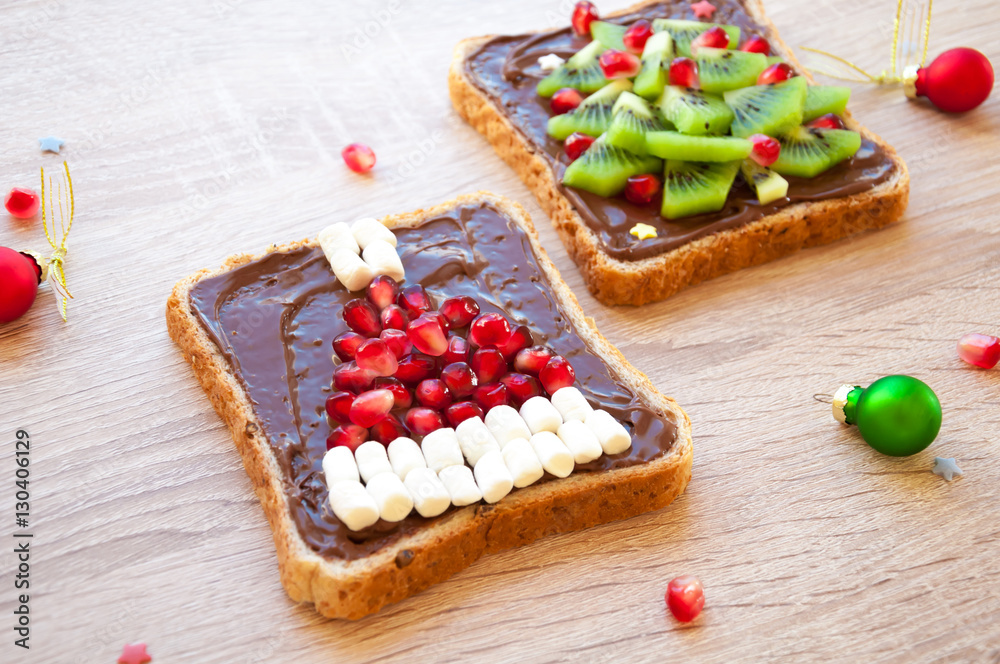Chocolate sandwich with pomegranate and marshmallow Santa hat and kiwi ...