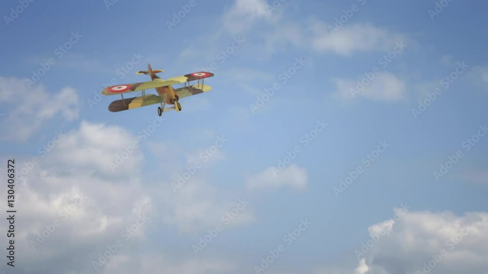 Flying biplane from World War with military camouflage. Model aircraft ...