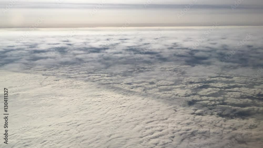 4K HD Video flying through thin cloud layer above a thick cloud layer ...