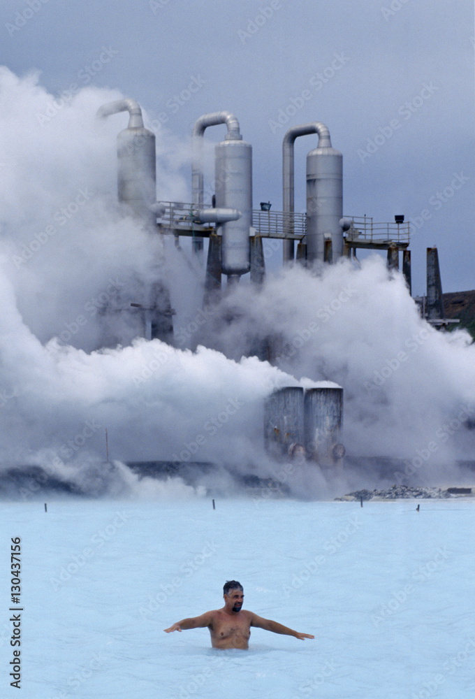 Clouds of steam rise as people swim in the Blue Lagoon thermal pool ...