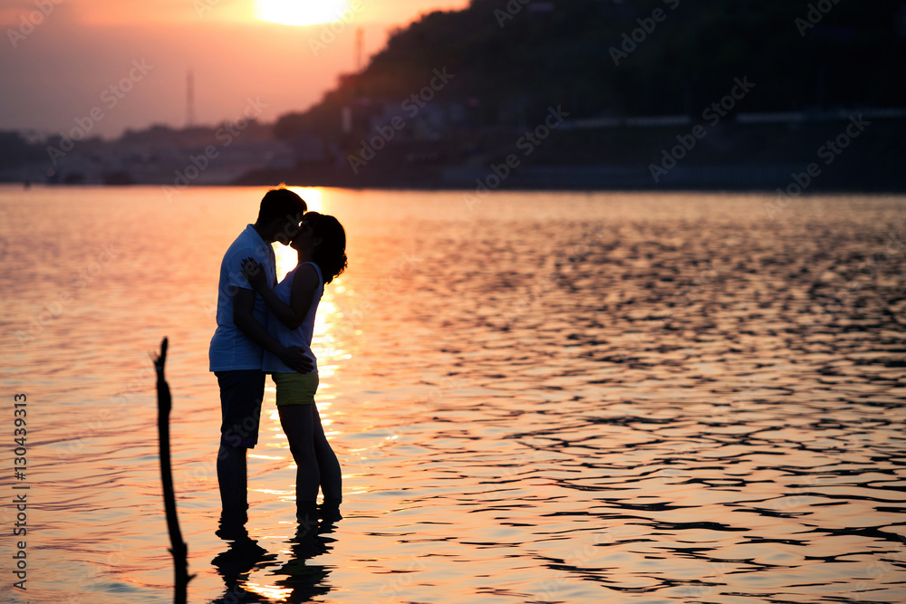 Romantic portrait of attractive couple in love hugs at the sunset ...