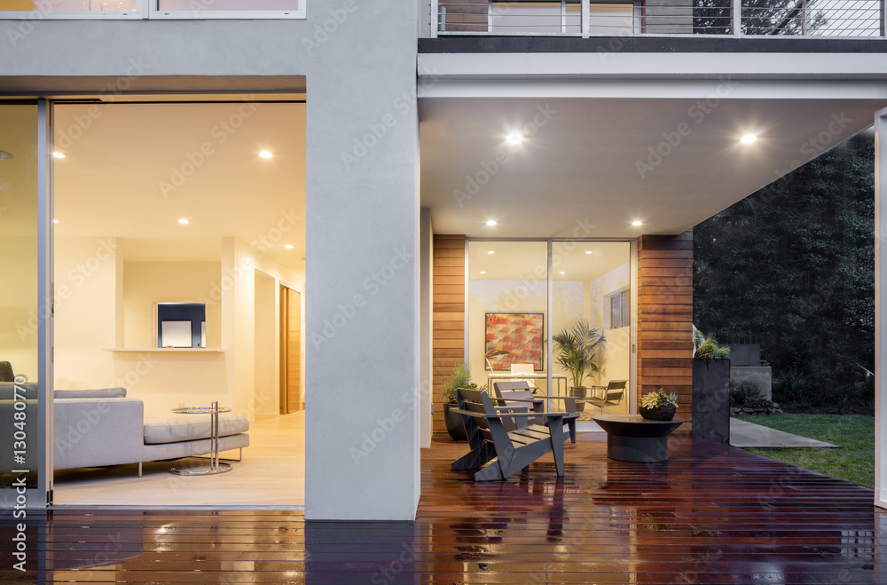 Open sliding door with wooden deck at night with furniture. Stock Photo ...