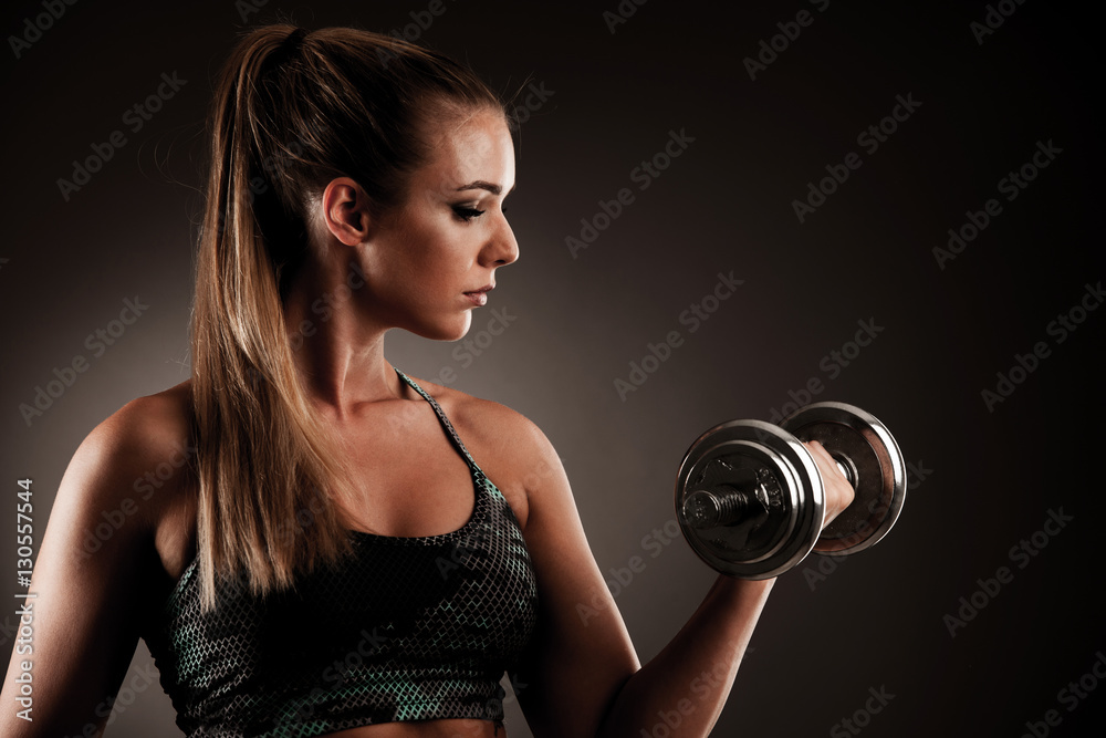 fit woman workout with dumbbells in gym studio photography of a Stock ...