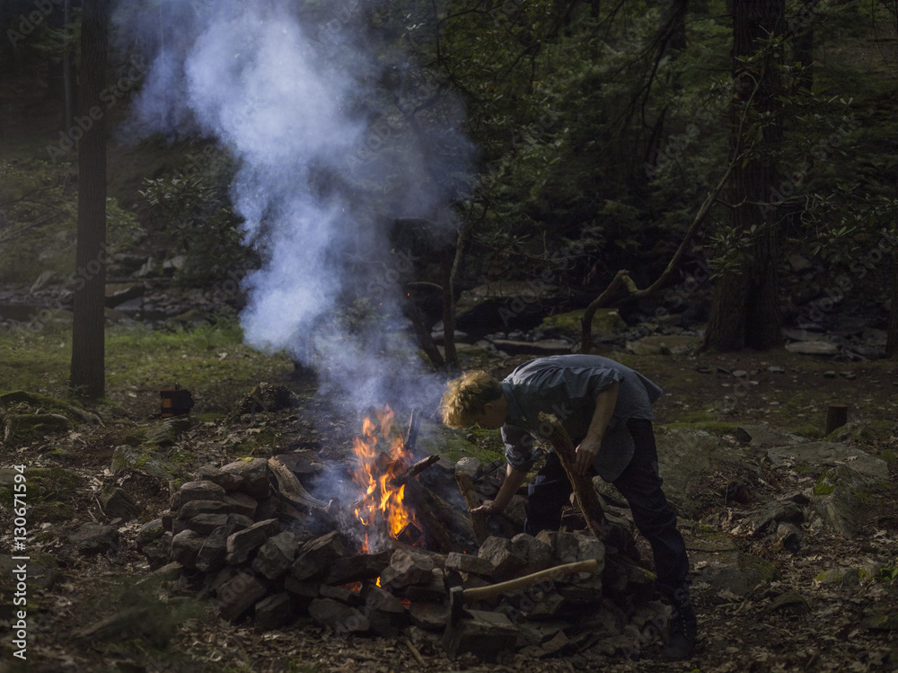 Person Tending Camp Fire