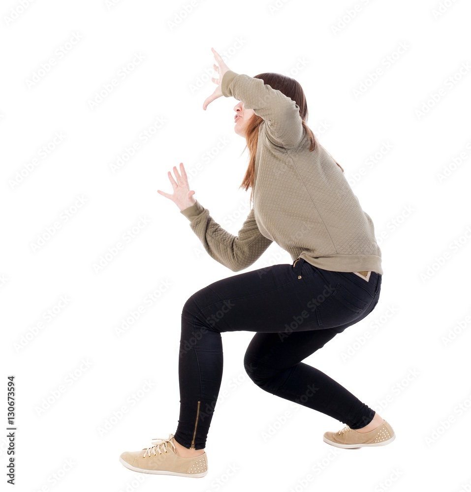 Side view. girl sat on his hands defensively on top of something ...