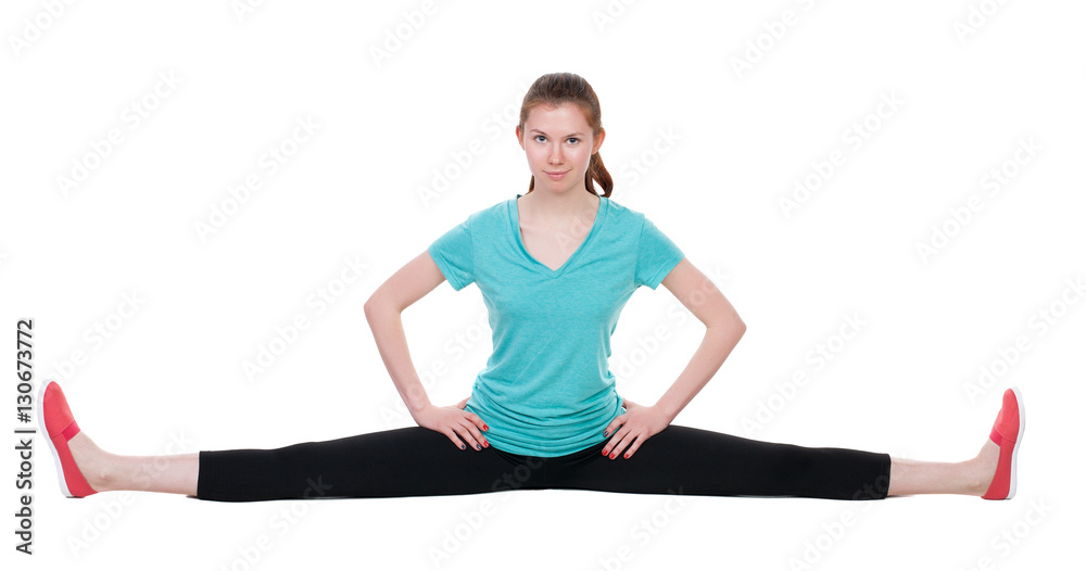 Front view of the girl in sportswear sitting on the longitudinal splits ...