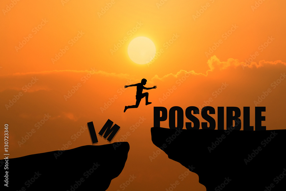 Man jumping over impossible or possible over cliff on sunset background ...