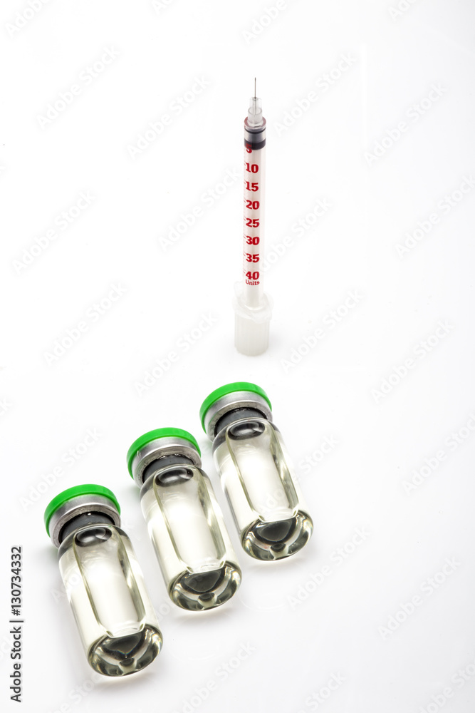 Three vials with green caps with insulin hormone. Medical 40 units ...