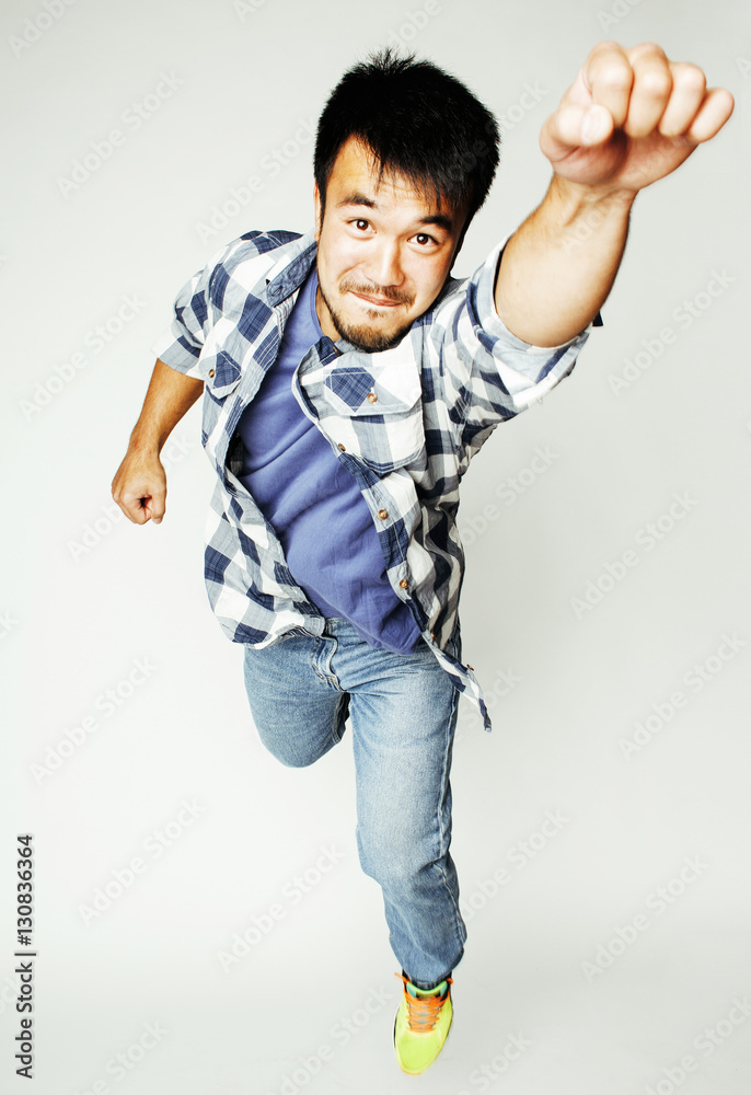 young pretty asian man jumping cheerful against white background ...