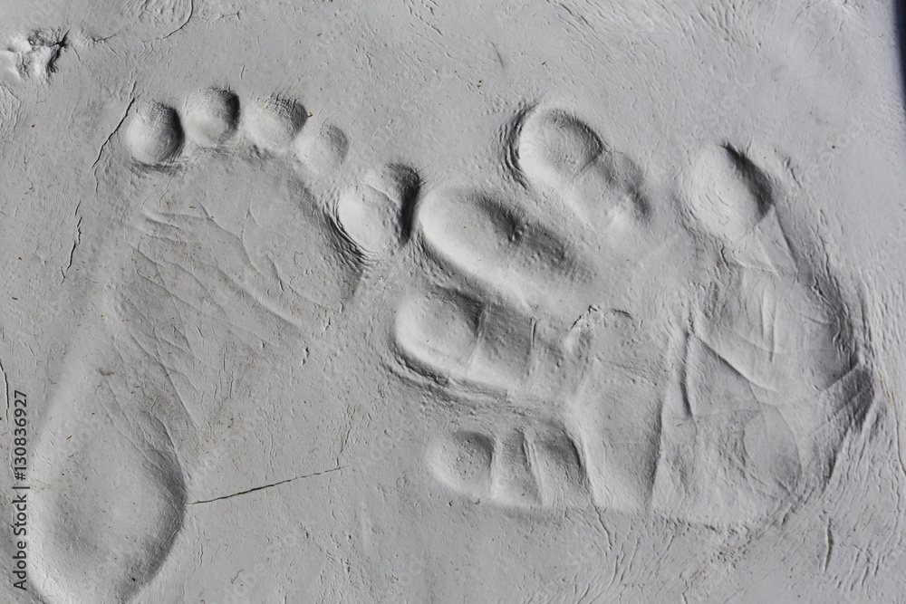 Tiny footprint and handprint texture on grey clay Stock Photo | Adobe Stock