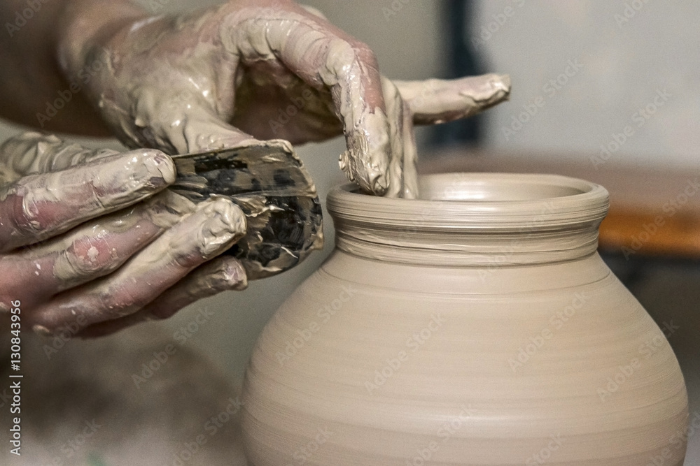 Making Crock crude wet close-up. Man hands and tool making clay jug ...
