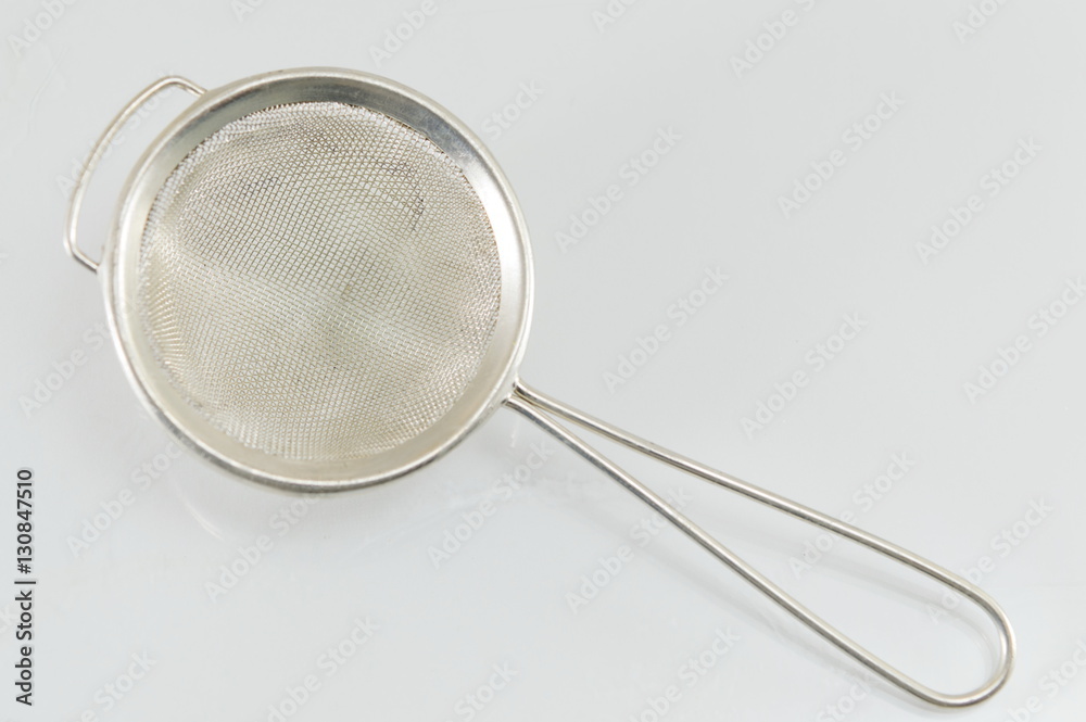 handheld colander tool on reflective background Stock-Foto | Adobe Stock