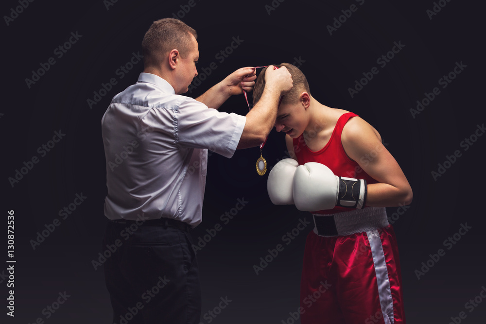 Boxing referee gives medal to young boxer Stock Photo | Adobe Stock