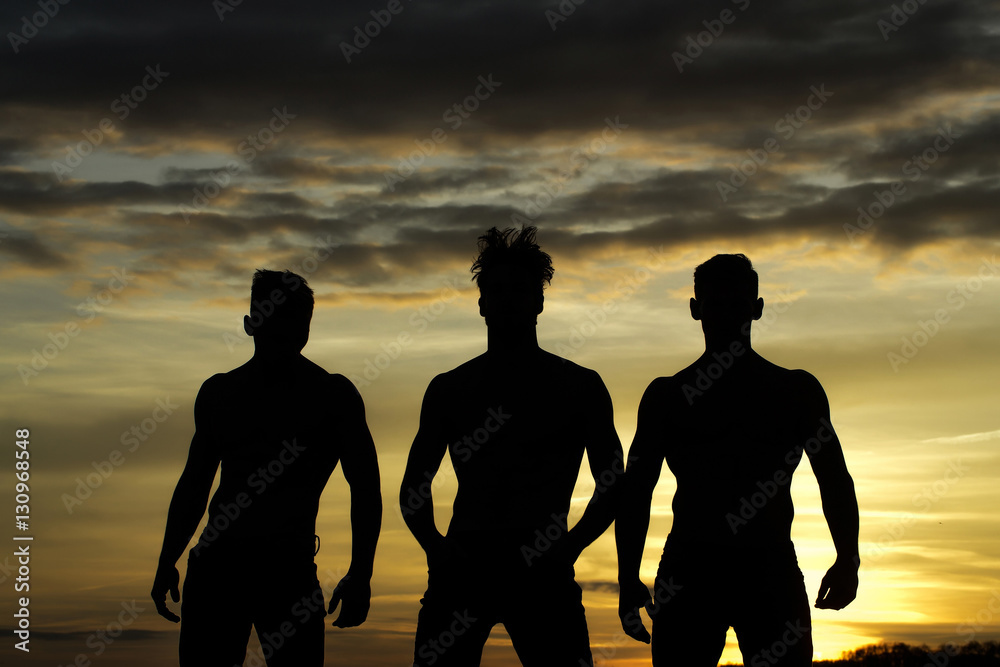 Handsome muscular men in sunset Stock Photo | Adobe Stock