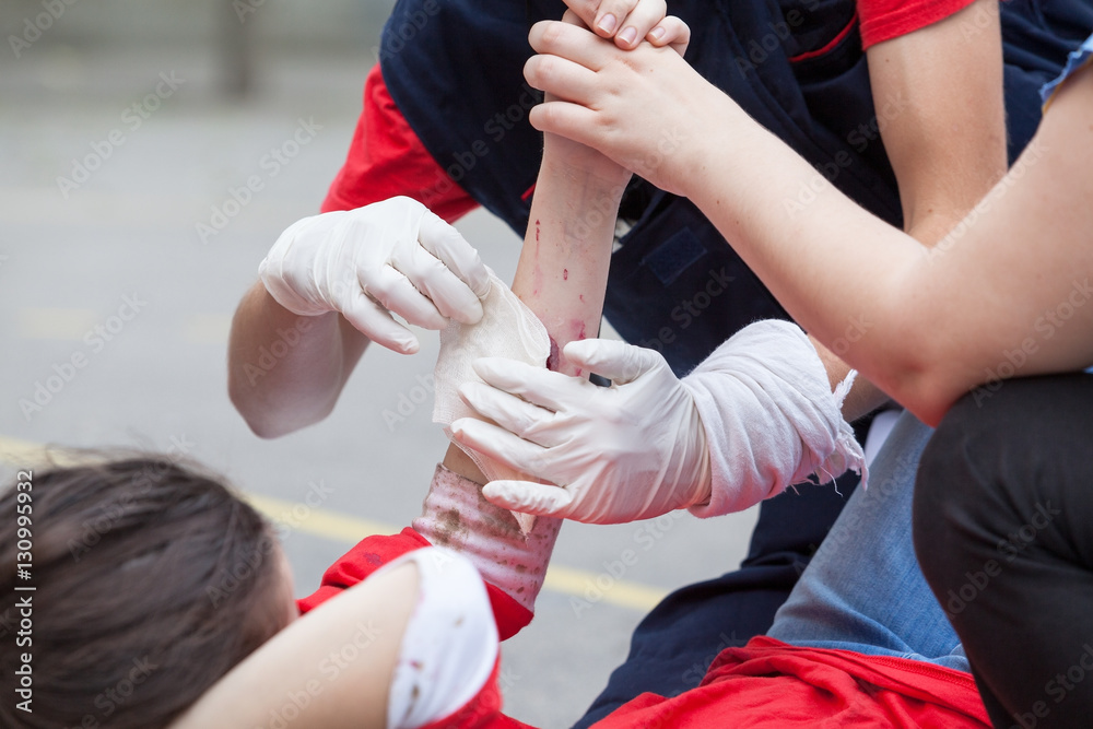 Paramedic giving help to an injured person after accident Stock Photo ...