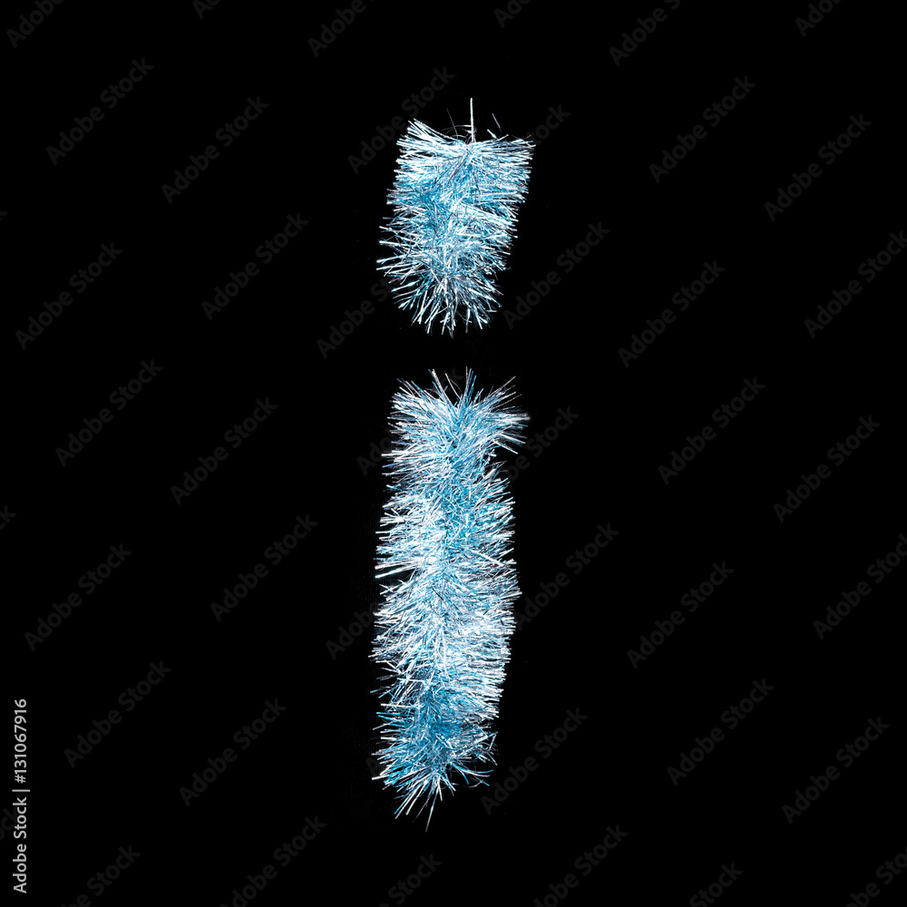 Festive alphabet made of blue tinsel. Letter I on black background ...