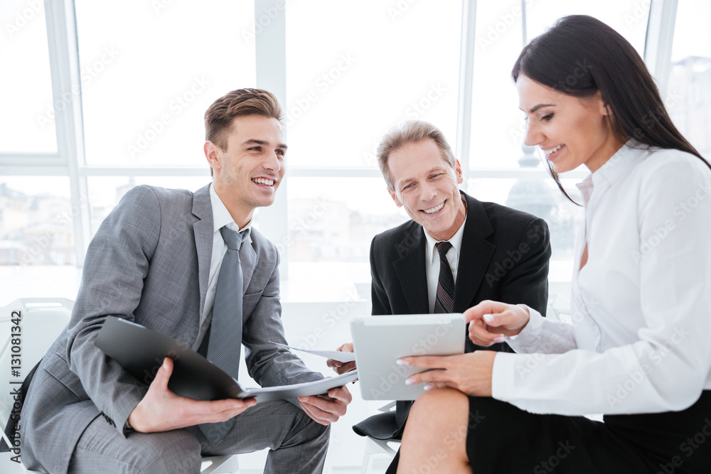 Three business people with tablet Stock Photo | Adobe Stock