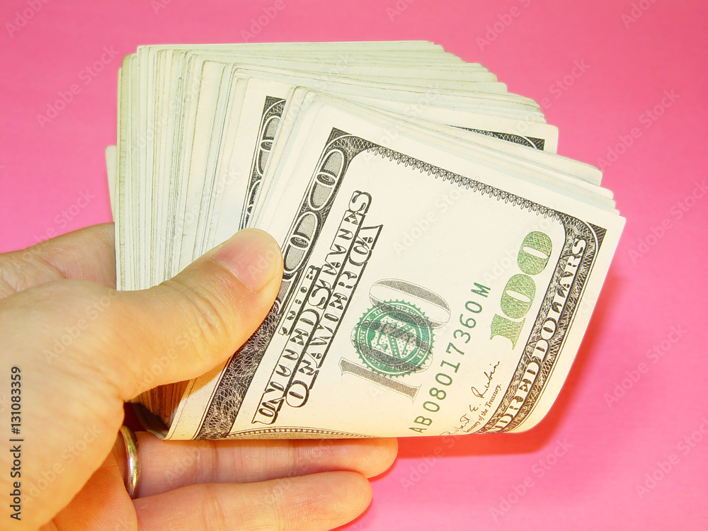 Handful of money. $100 dollar bills. US notes. us currency. us dollars ...