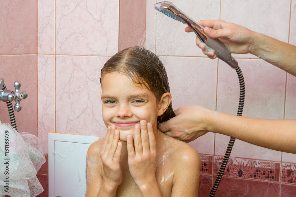 Seven-year girl bathe in a bath under the shower Stock Photo | Adobe Stock