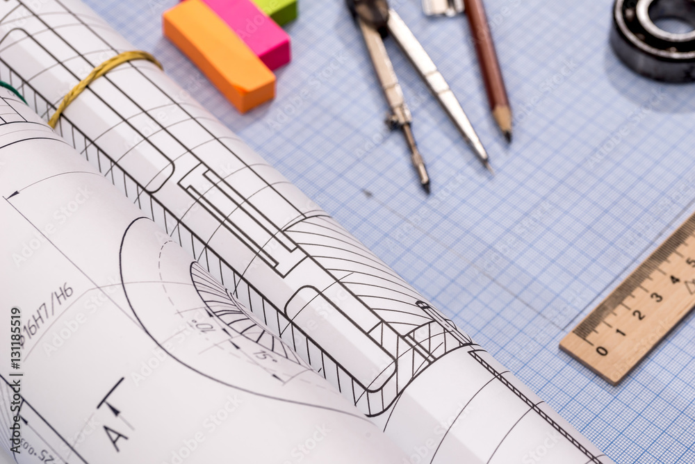 technical project drawing above graph paper with engineering tools ...