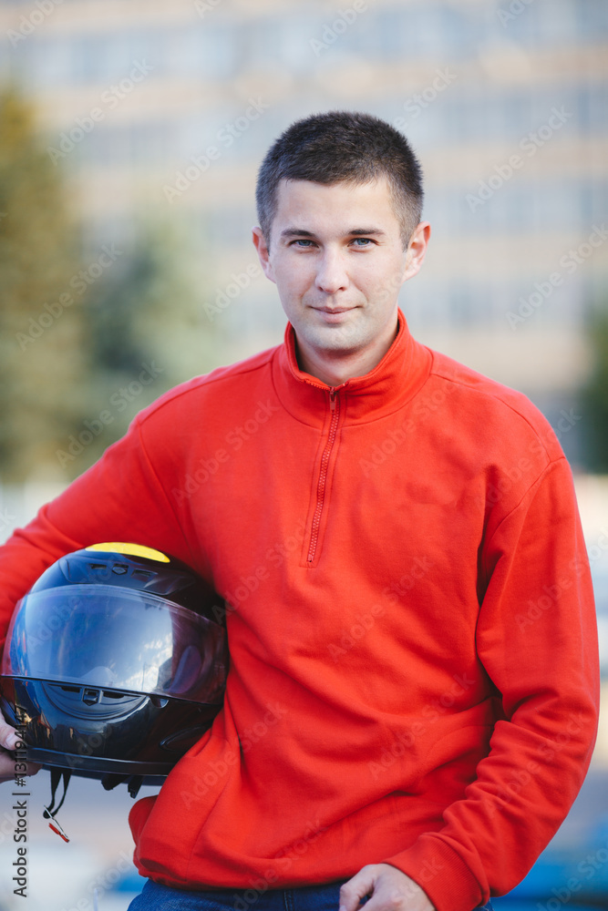 Race driver in red suit with helmet in hand portrait Stock Photo ...