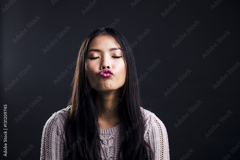 Beautiful Young Asian Woman Pouting Stock Photo | Adobe Stock