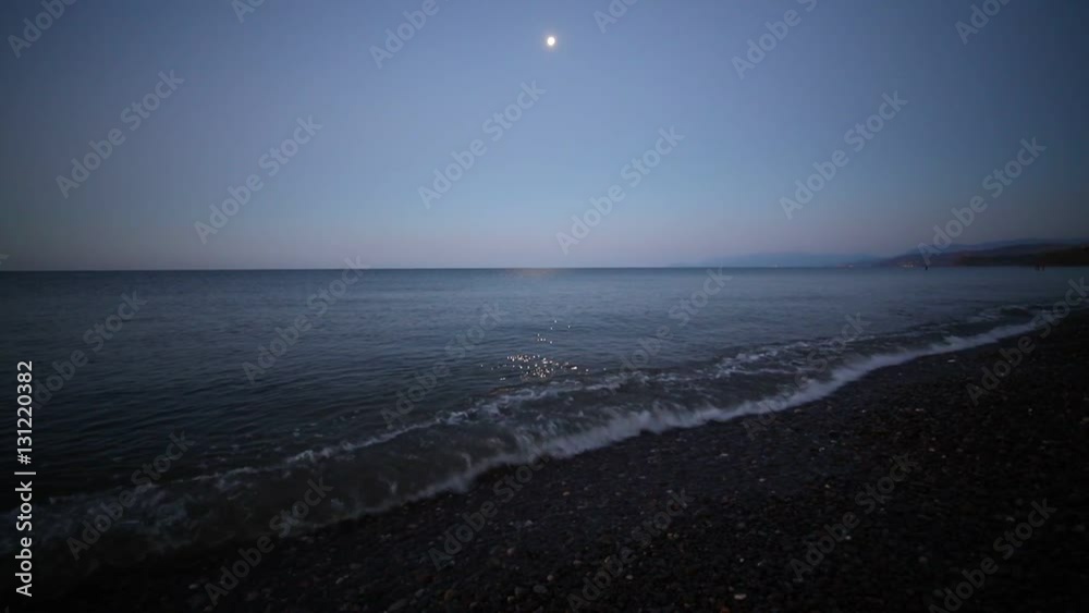 Night calm sea waves idyllic shore beach with turquoise water pebbles ...
