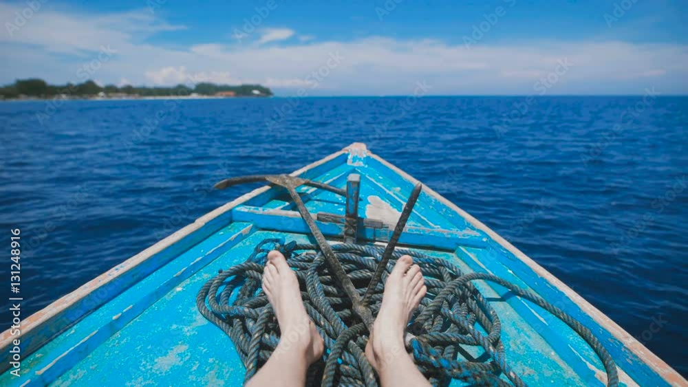 Ocean island of Bali. Boat tour. Young man in a boat on the ocean ...