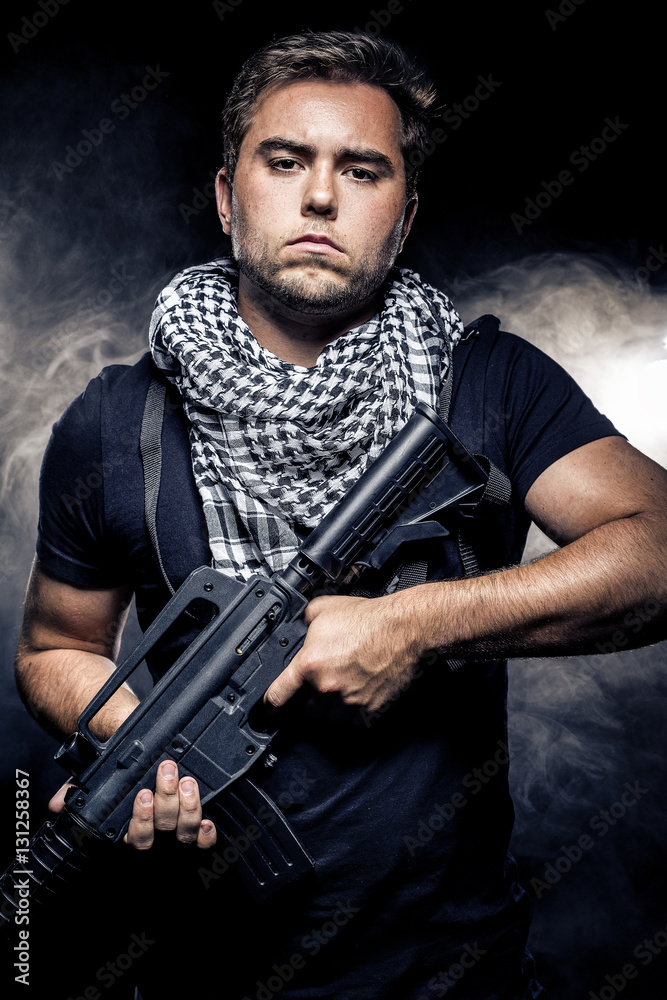 Soldier or mercenary wearing a shemagh with assault rifle, paintball or ...