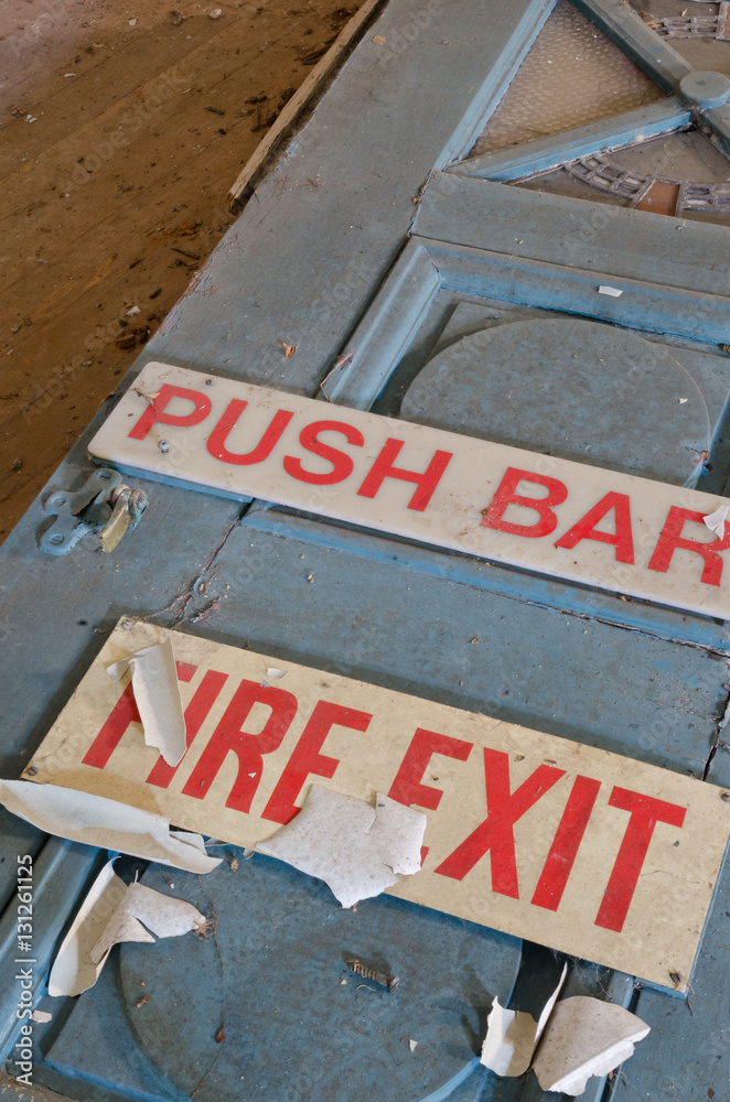 An old abandoned wooden fire escape door in a decaying forgotten ...