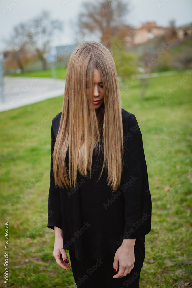 Blond girl with long blonde hair covering her face Stock Photo | Adobe ...