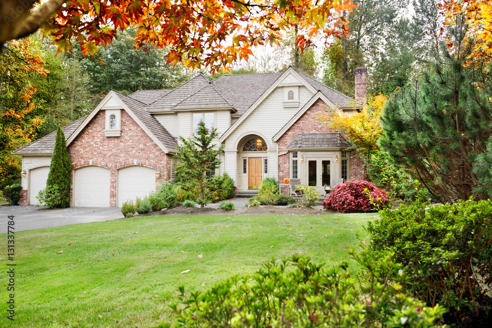 Suburban home from the front garden in early Autumn as the leaves begin ...