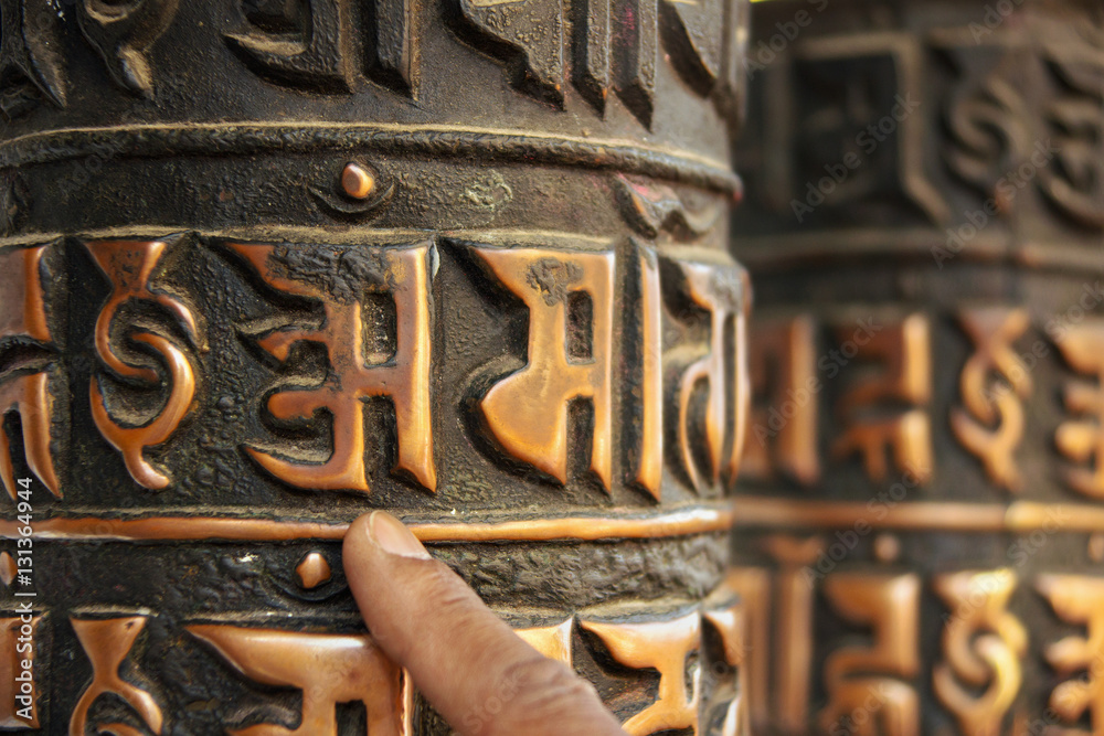 Poster A human finger of local man indicates the buddhist sign Om ...