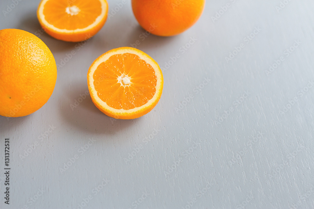 A beautiful yellow color of oranges, orange slices, laying on the top ...