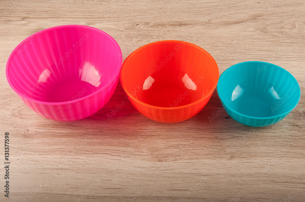 Composition of three different size plastic containers on table Stock ...