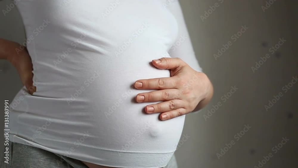 Pregnant woman stroking her belly. Slow motion Stock Video | Adobe Stock
