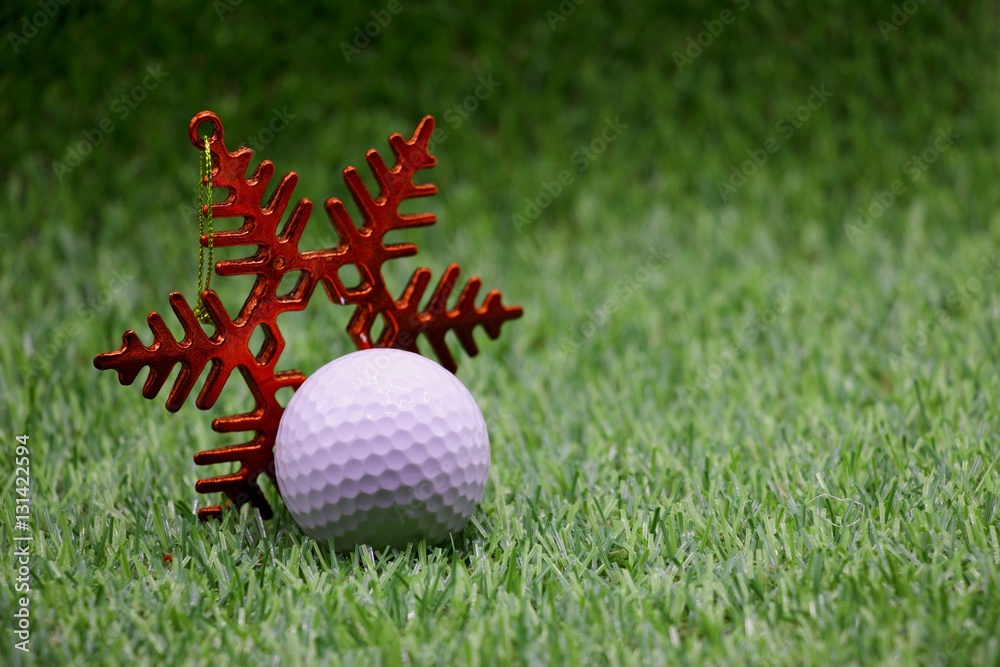 golf ball with snow flake on green grass Stock Photo | Adobe Stock