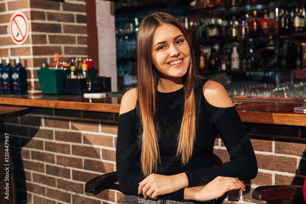 beautiful young woman sitting at the bar Stock 사진 | Adobe Stock