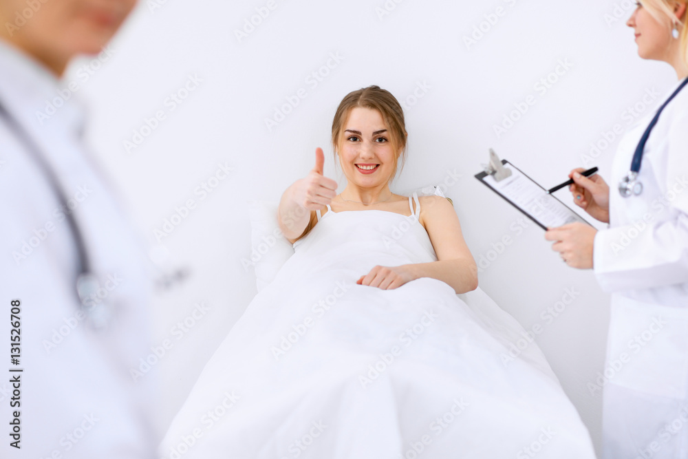 Happy smiling patient shows thumbs up in hospital Stock Photo | Adobe Stock