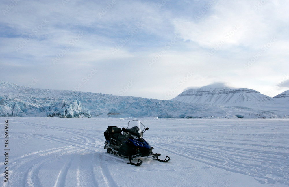 The snowmobile on the frozen fjord. This photo shows the snowmobile on ...
