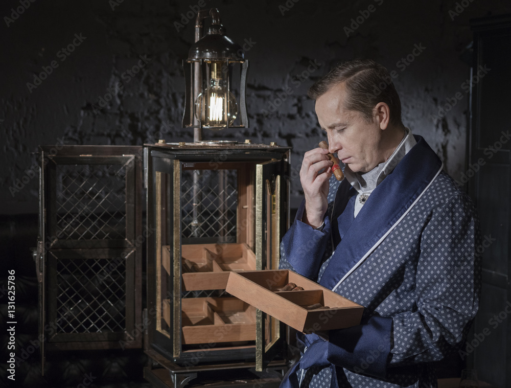 Man in an elegant dressing gown smoking a Cuban cigar and drinking ...