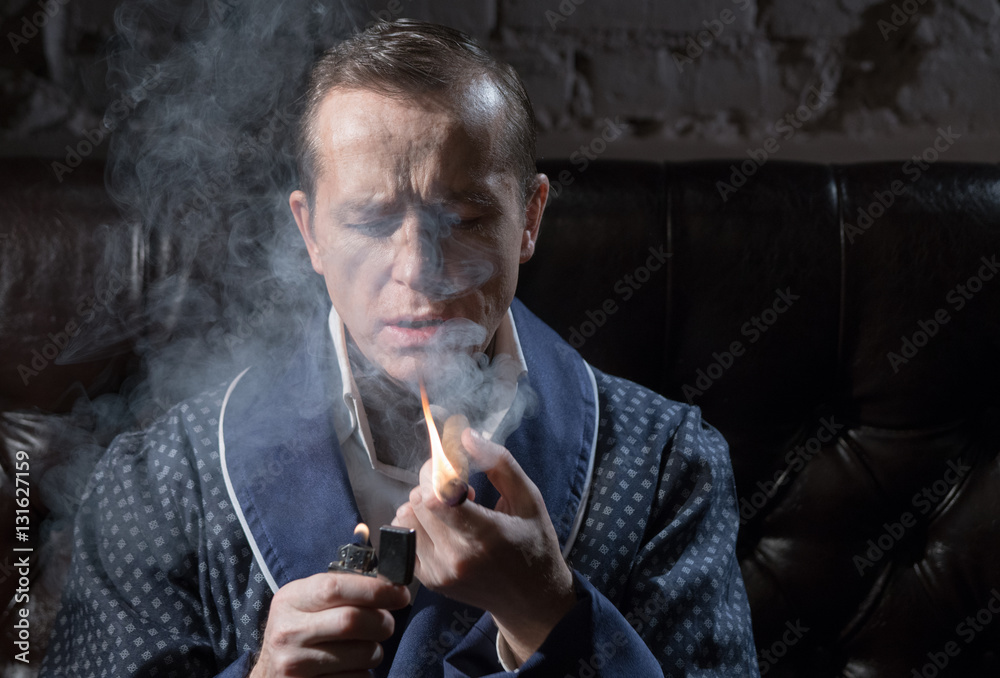 Man in an elegant dressing gown smoking a Cuban cigar and drinking ...