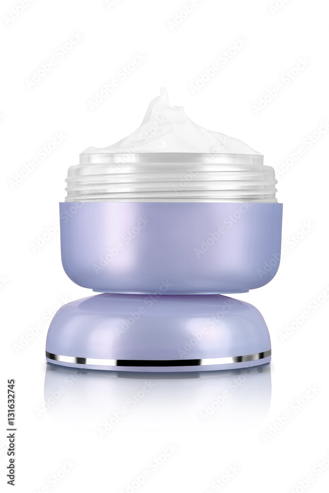 Facial cosmetic creme in blank blue glossy open jar sitting on it`s lid ...