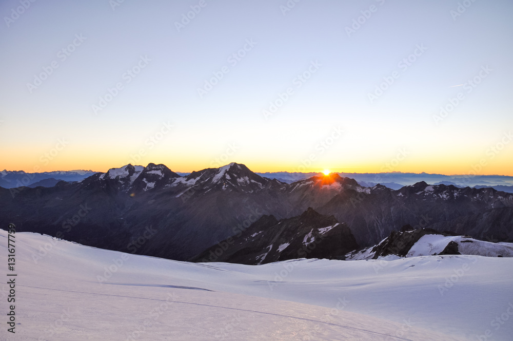 Stunning sunrise at 3800m amsl in the Swiss Wallis Alps near the summit ...