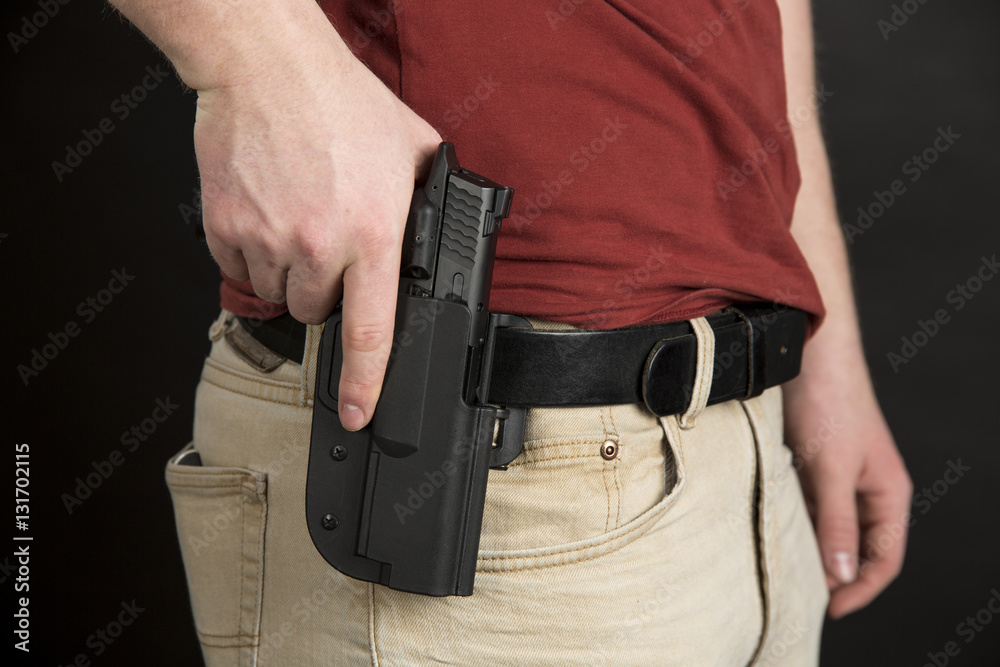 Armed man with semi-automatic in home invasion scenario Stock Photo ...