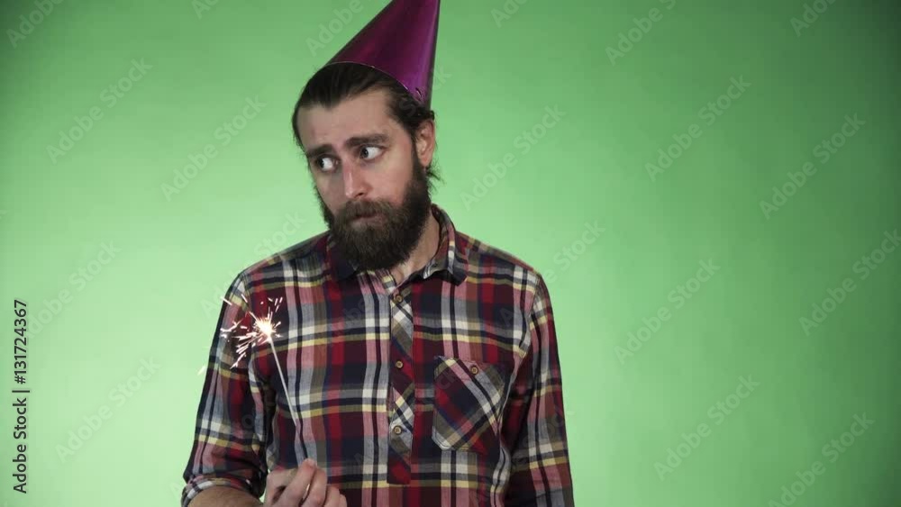 Vídeo do Stock: Young boring sad man celebrating with a sparkler in his ...