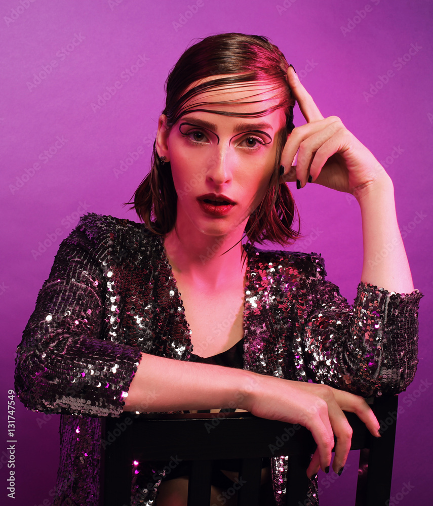 fashion model posing over purple background Stock Photo | Adobe Stock