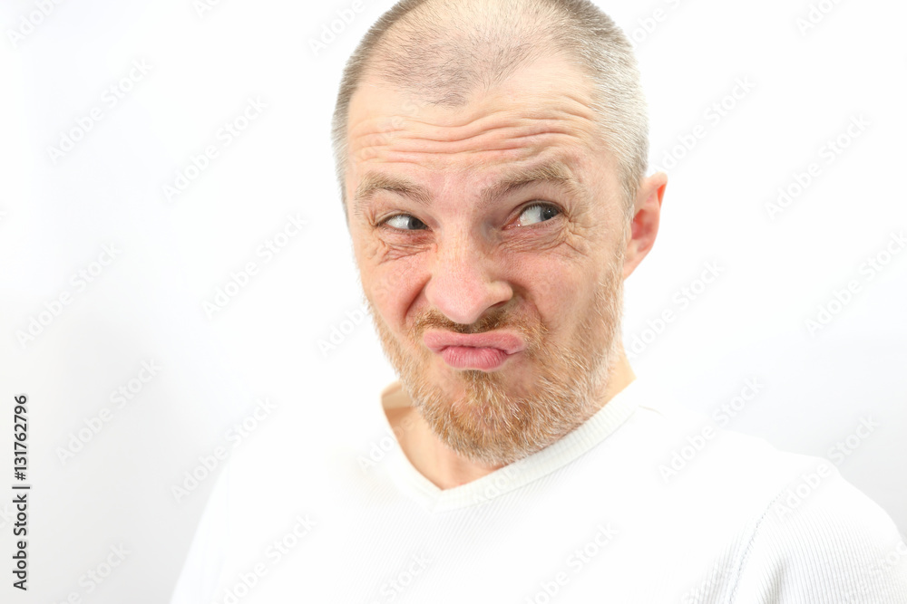 grown man dressed in white makes emotional facial expressions Stock ...