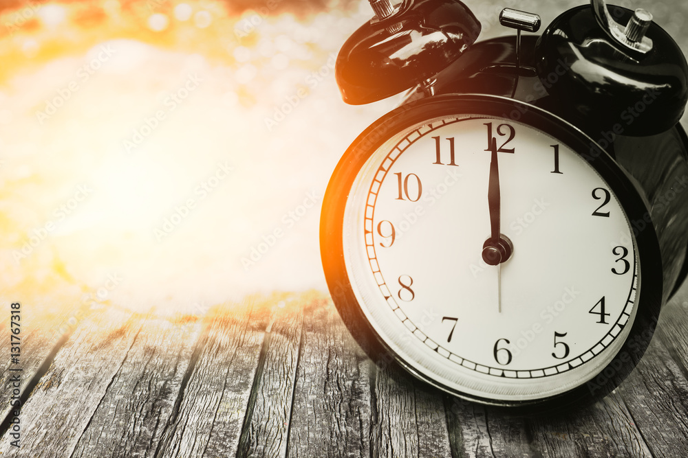 old memory time concept, retro clock timed at 12 o'clock on wood with ...